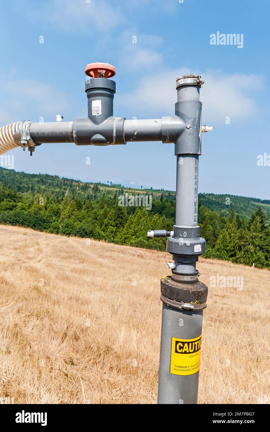 A vertical landfill methane gas wellhead and valve at an active ... A vertical landfill methane gas wellhead and valve at an active ...