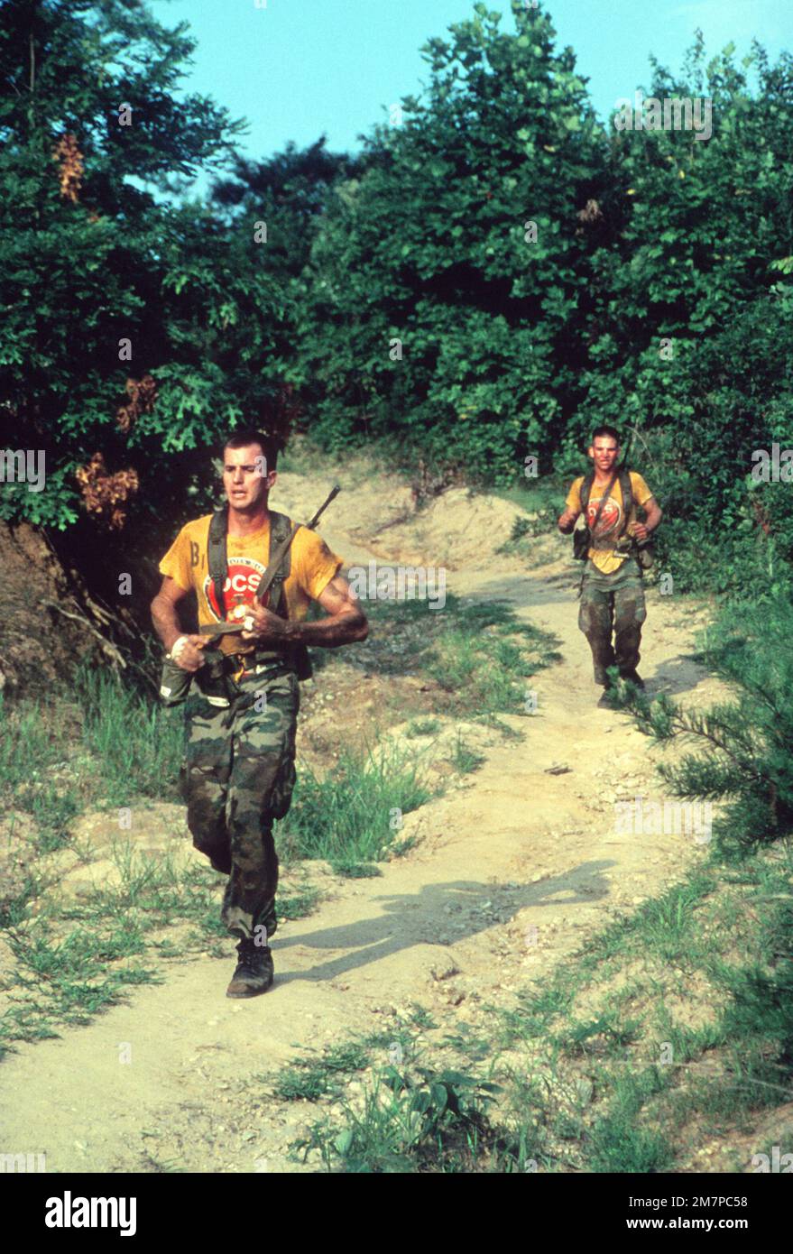 Two Marine officer candidates take their turn at the endurance run ...