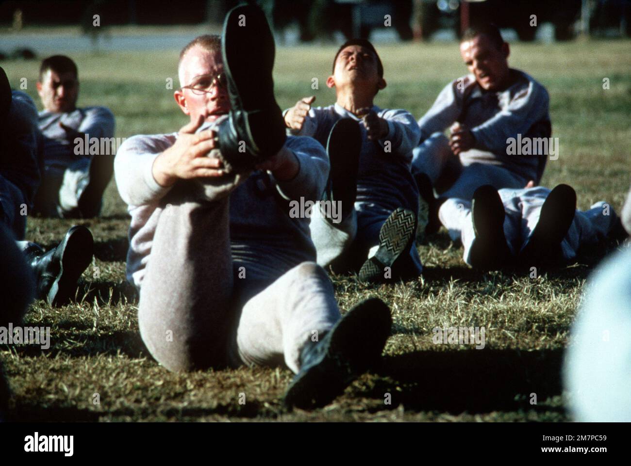 Marine officer candidates do a sit-up exercise as part of their ...