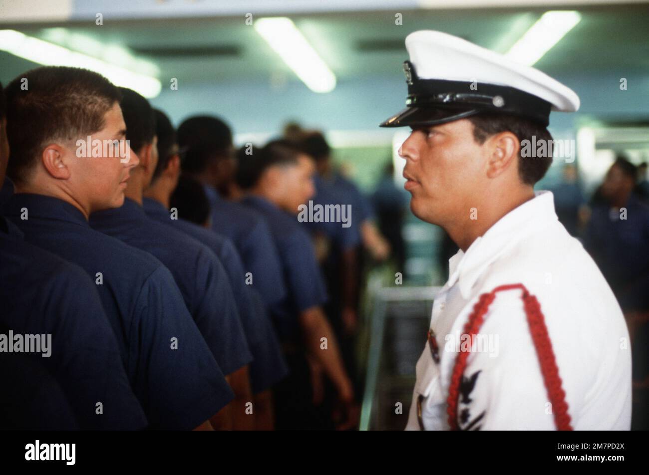 Recruits line up in the dining hall at the Naval Training Center as ...