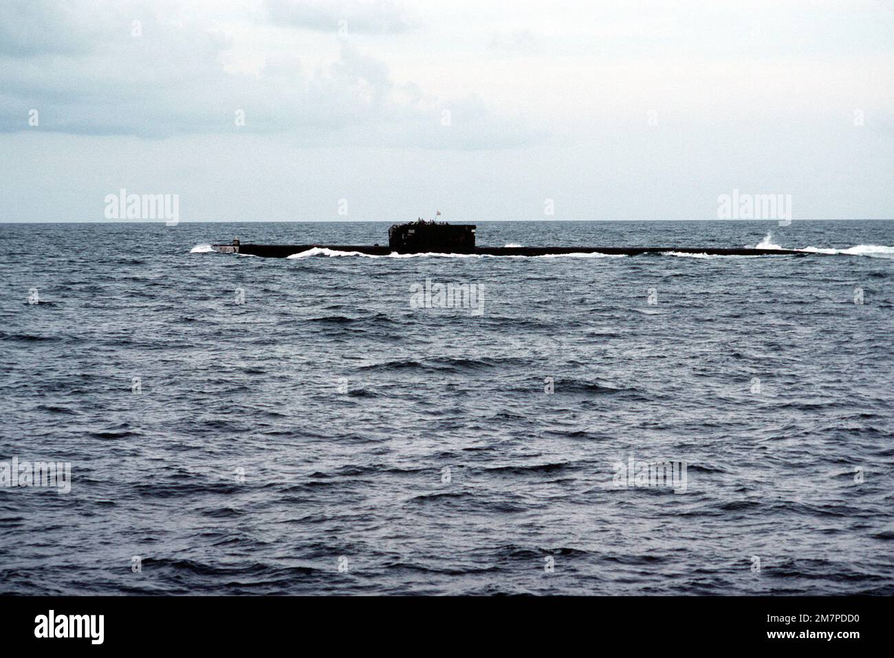 An aerial port beam view of a Soviet Juliett class submarine underway ...
