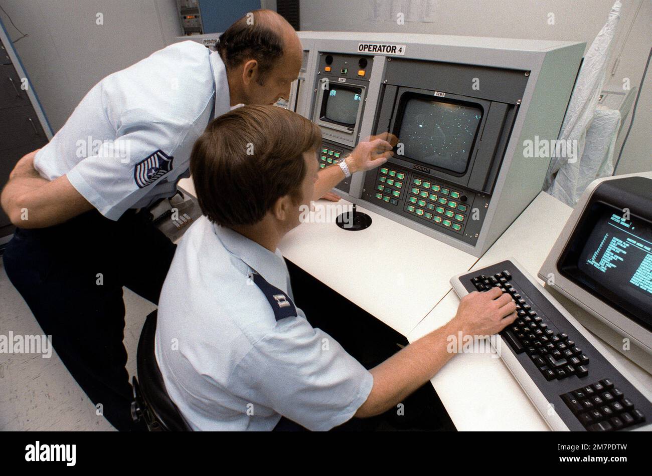 An enlistee and officer operate a console at the Ground Electro Optical ...