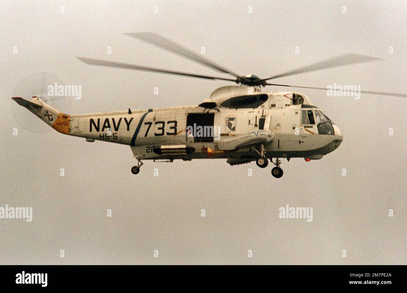 An SH-3 Sea King helicopter approaches for a landing on the flight deck ...