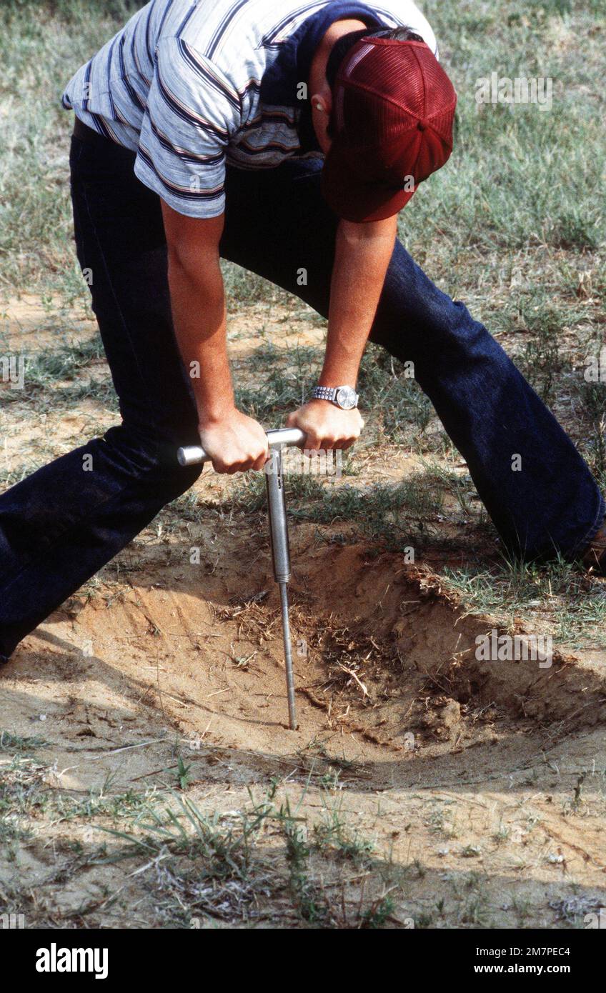 A penetrometer runway softness measurement is taken in a test pit ...