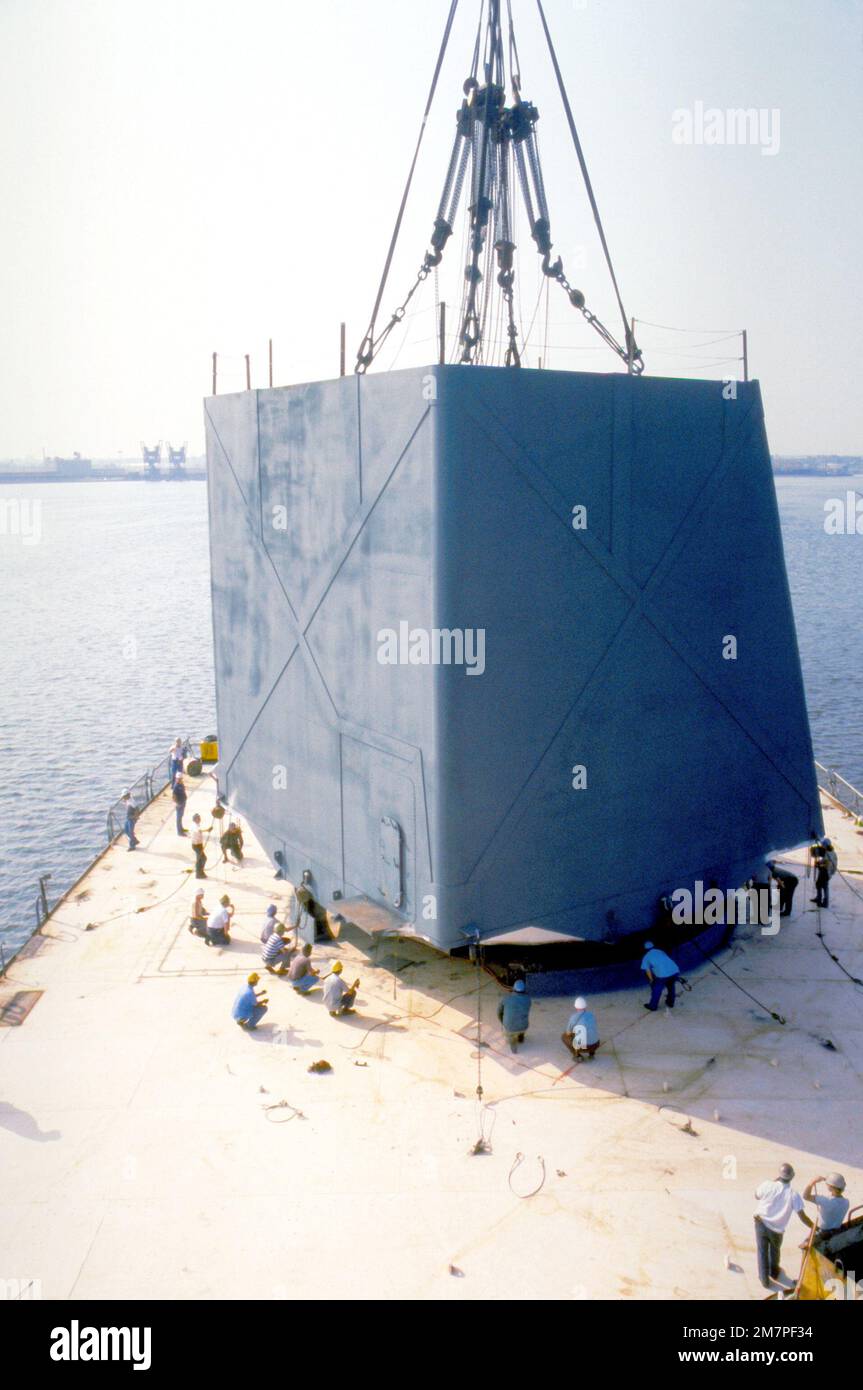The radar turret is being lifted o onto the stern of the USNS ...