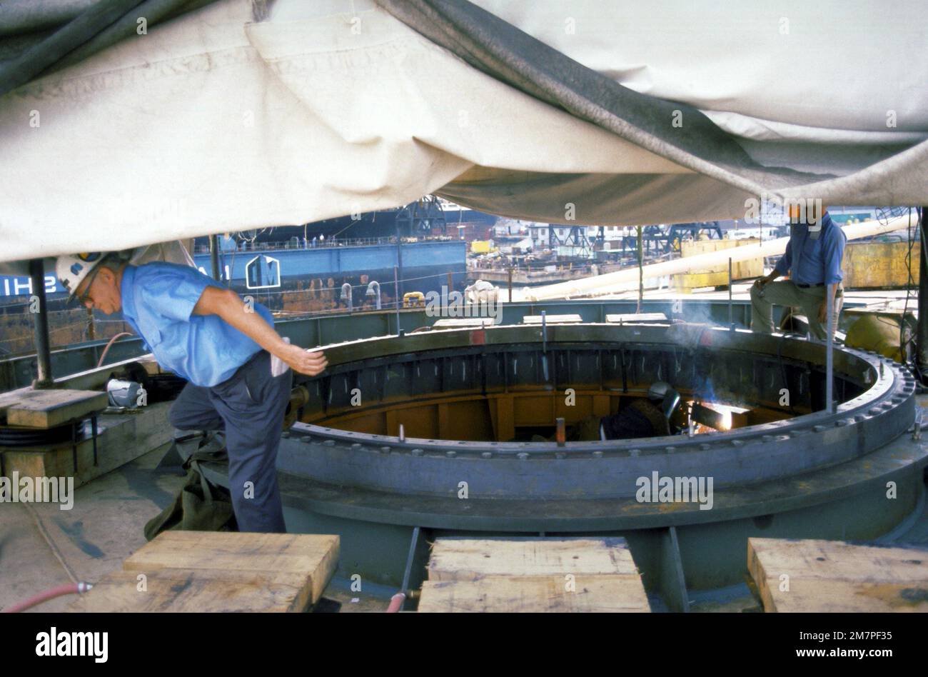 Finishing touches are made on the radar turret mount of the USNS ...