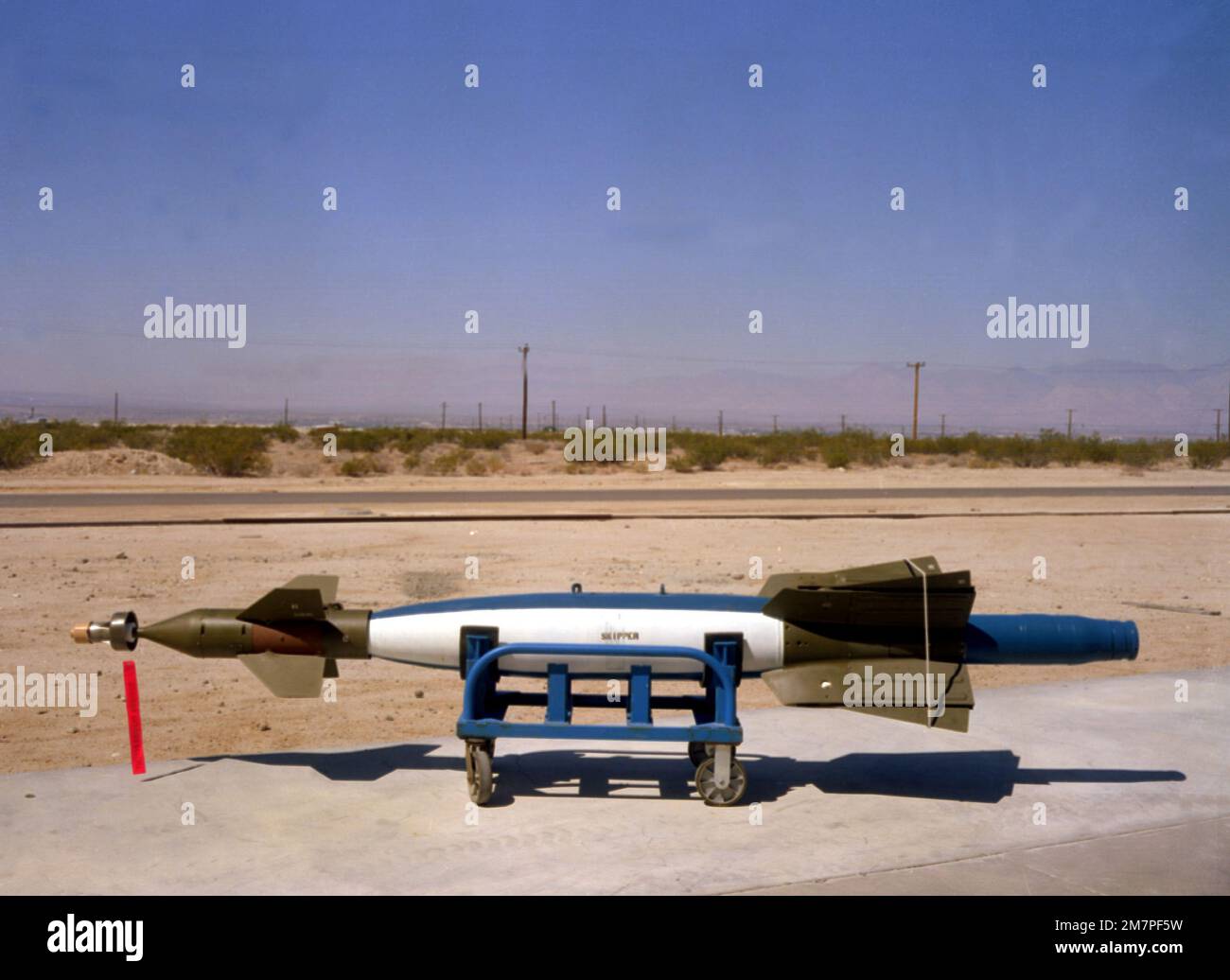A left side view of a Skipper laser-guided bomb (LGB) with fins restrained while on a dolly ...