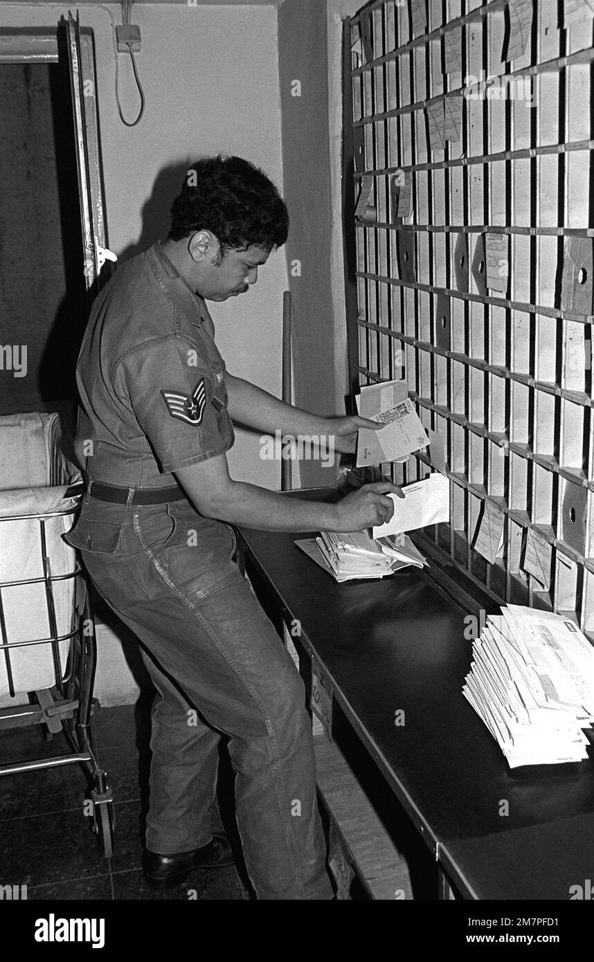 A staff sergeant puts mail into individual boxes in the post office at ...