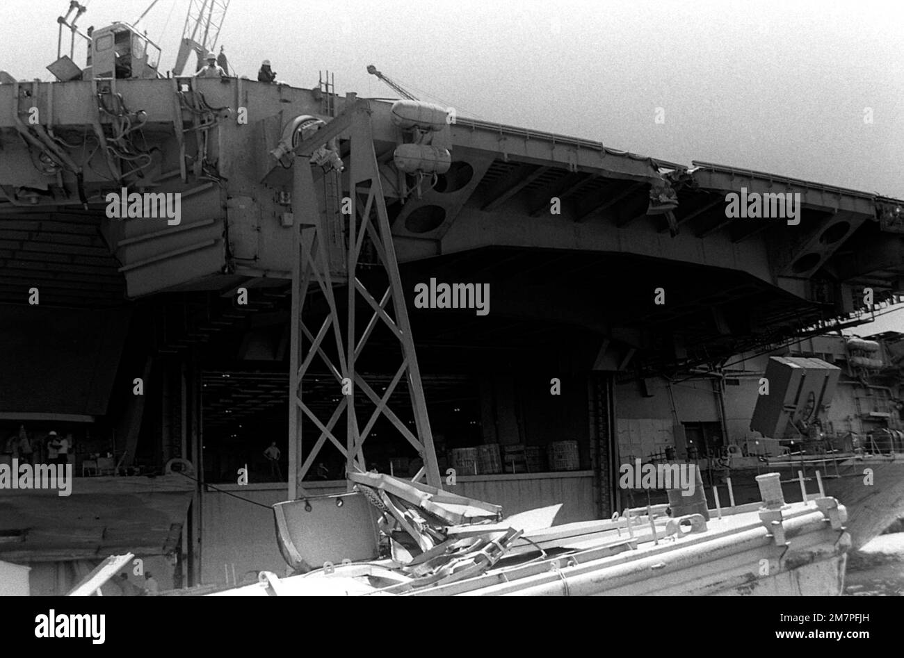A view of damage caused to the port side of the aircraft carrier USS ...