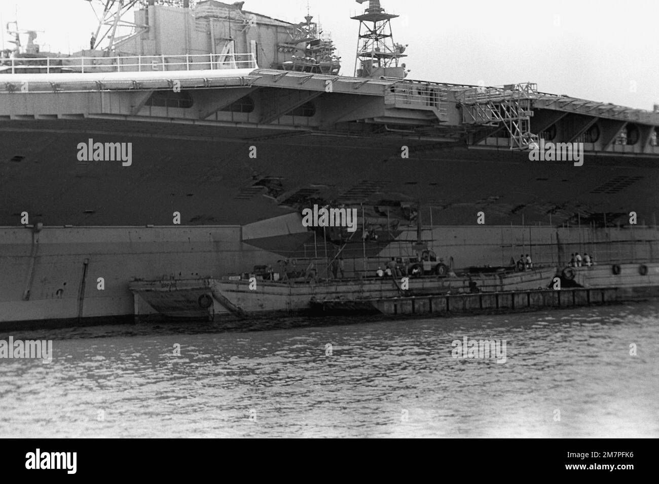 A view of damage caused to the port amidships section of the aircraft ...