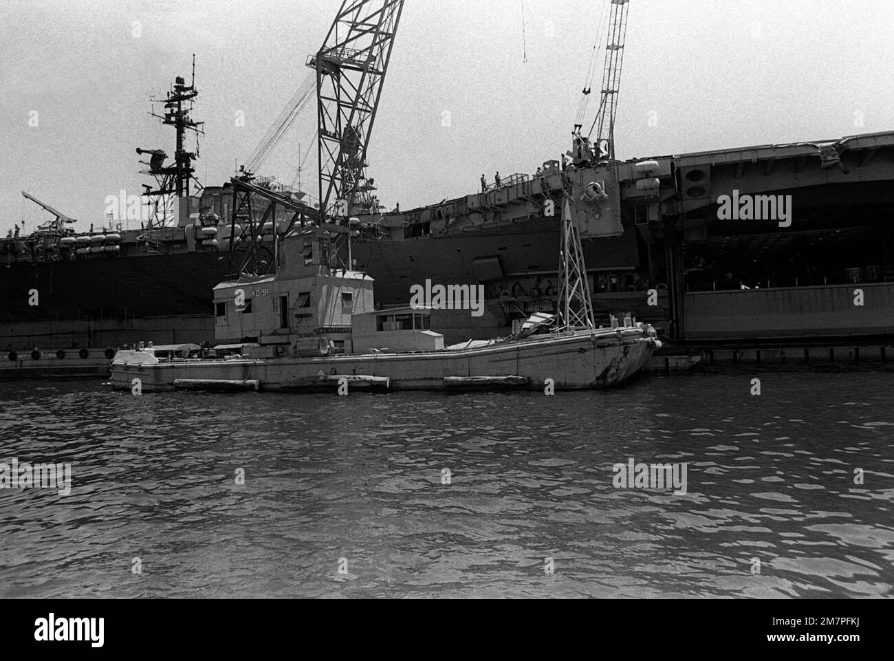 A view of damage caused to the port amidships section of the aircraft ...