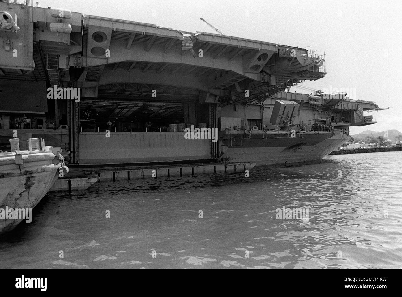 A view of damage caused to the port side aircraft elevator of the ...