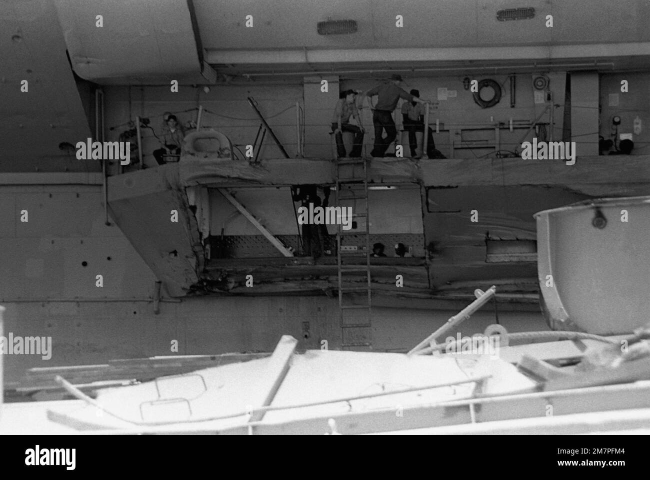 A view of damage caused to the port side of the aircraft carrier USS ...