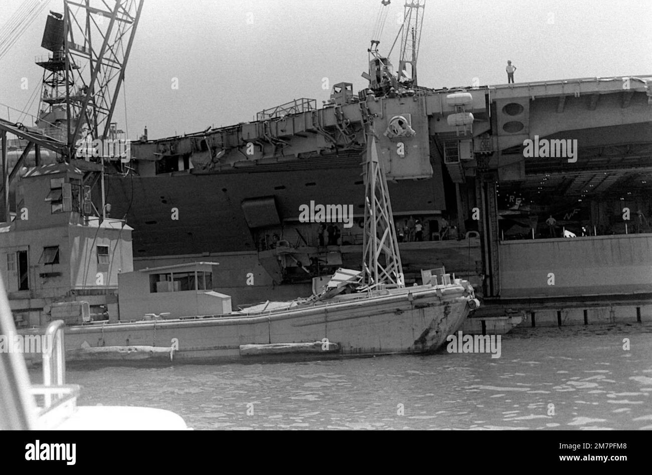 A view of damage caused to the port side of the aircraft carrier USS ...