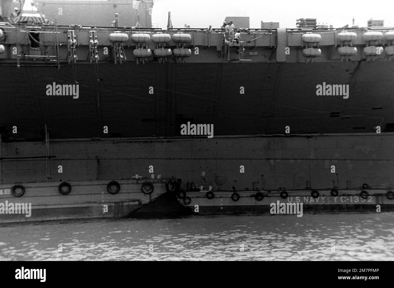 A view of damage caused to the port amidships section of the aircraft ...