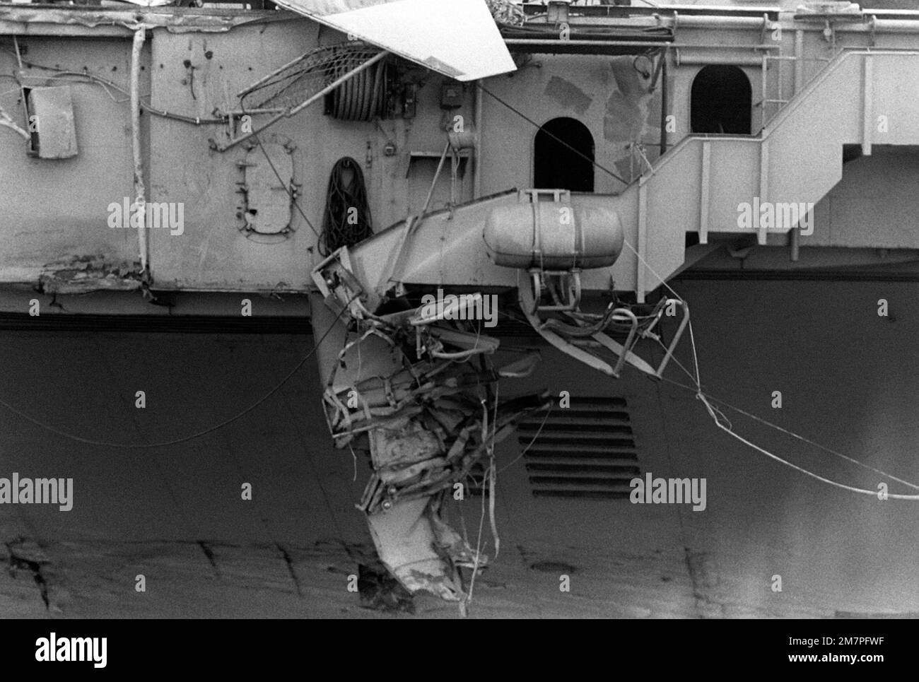 A view of damage caused to the port amidships section of the aircraft ...