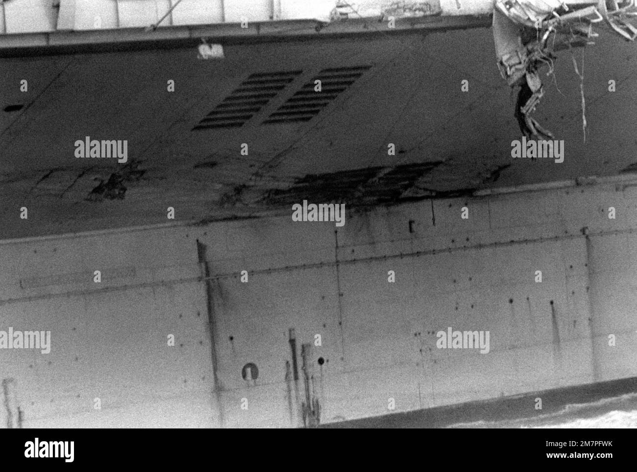 A view of damage caused to the port amidships section of the aircraft ...