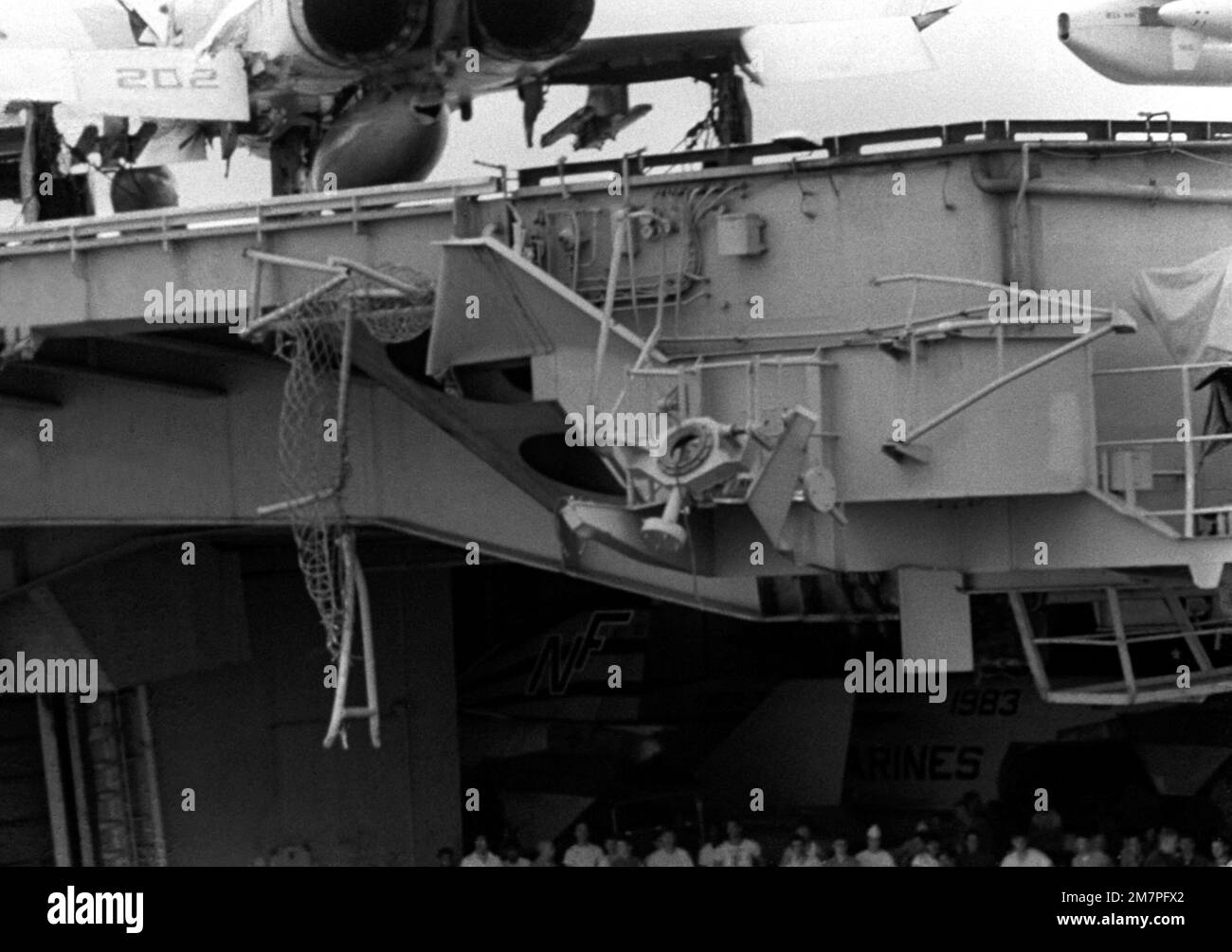 A view of damage caused to the port side aircraft elevator of the ...