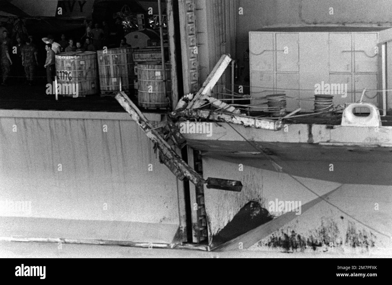 A view of damage caused to the port side aircraft elevator of the ...