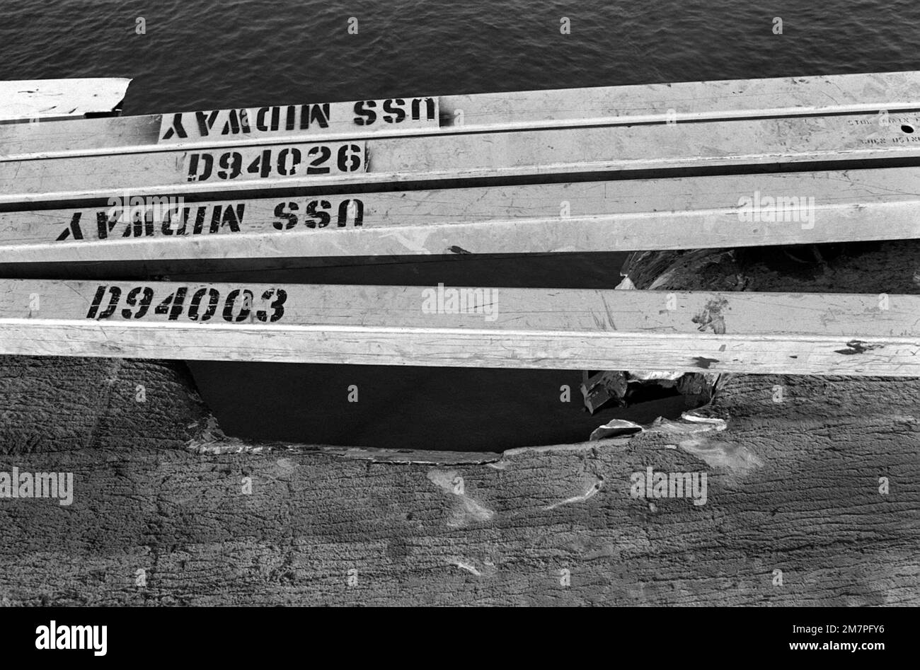 A view of damage caused to the port side deck of the aircraft carrier ...