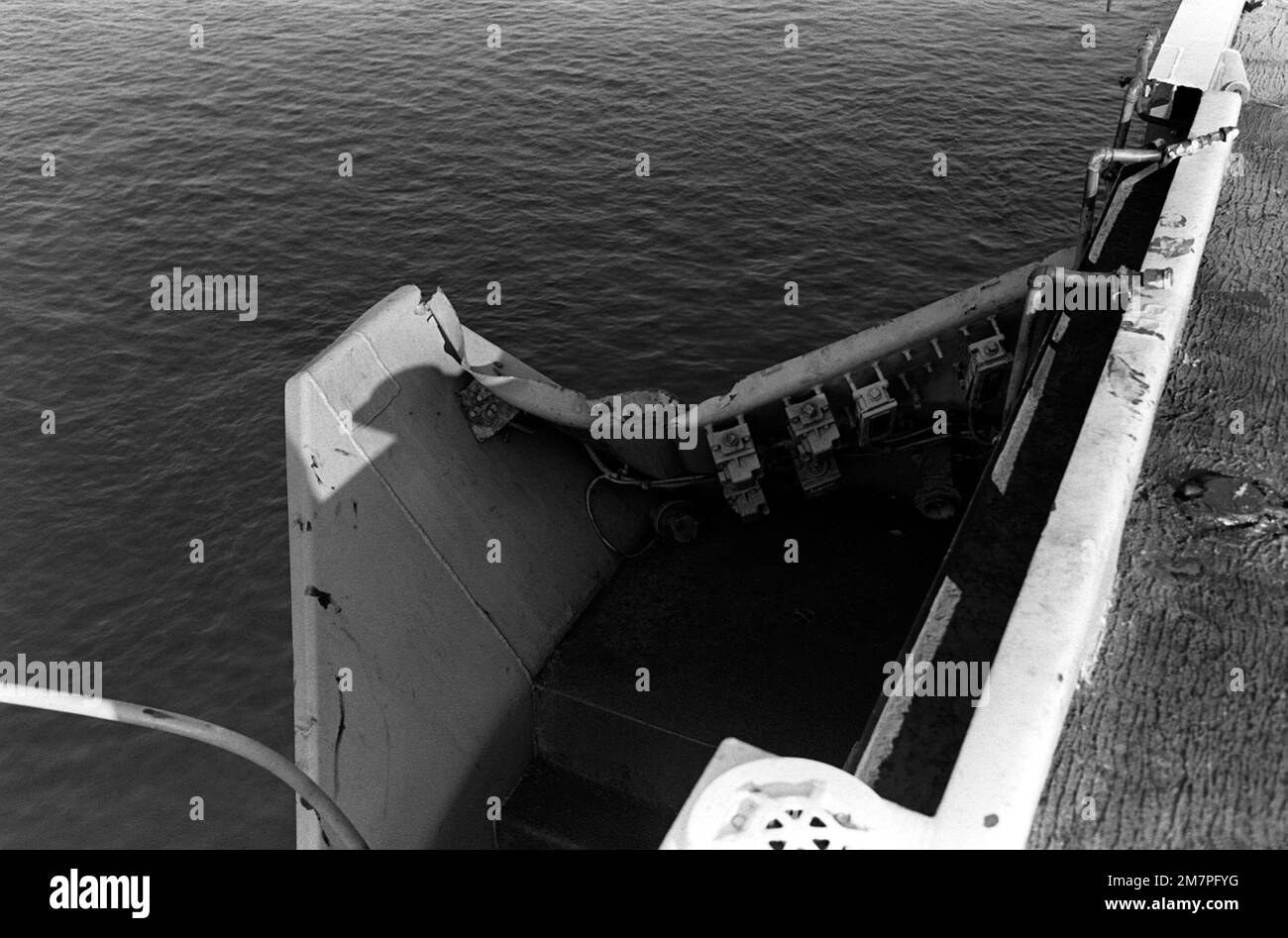 A view of damage caused to the port side of the aircraft carrier USS ...