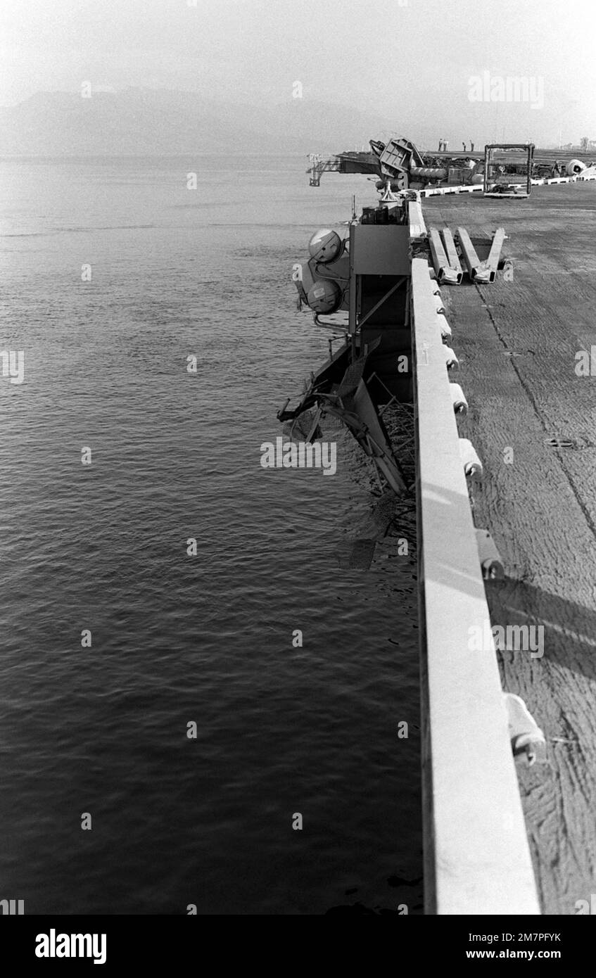 A view of damage caused to the port side of the aircraft carrier USS ...