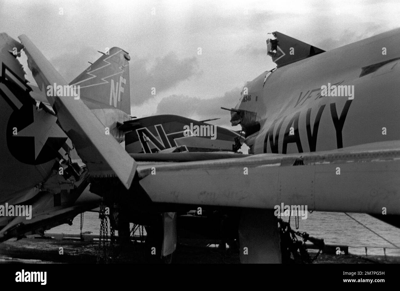 A view of damage caused to two F-4 Phantom II aircraft that were parked ...