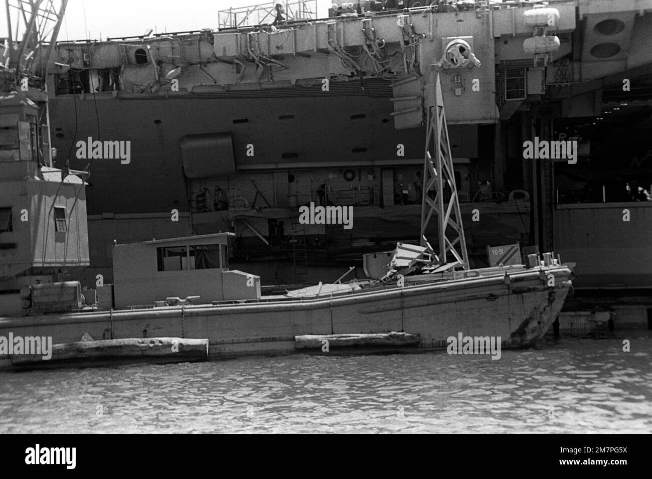A view of damage caused to the port side of the aircraft carrier USS ...