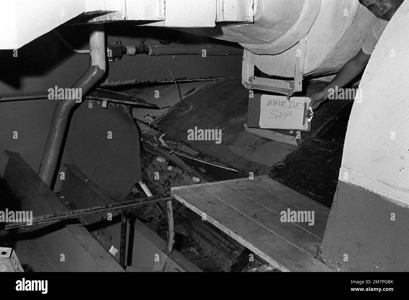 An interior view of damage caused to the aircraft carrier USS MIDWAY ...