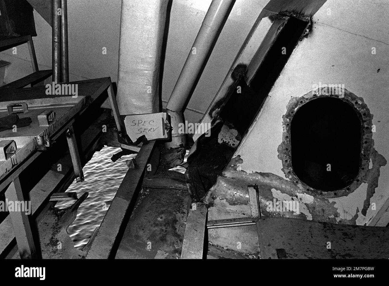 An interior view of damage caused to the aircraft carrier USS MIDWAY ...