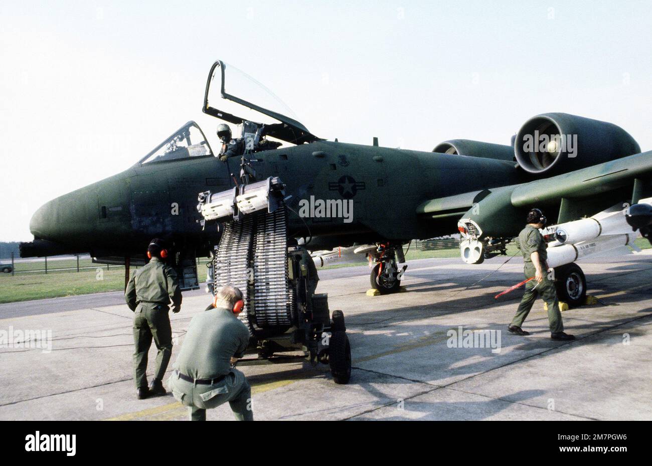 The pilot of this A-10A Thunderbolt II aircraft waits for the flight line crewmen to reload his ...