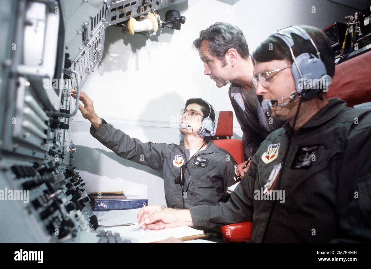 U.S. Air Force officers work with their consoles aboard an E-3A Sentry ...