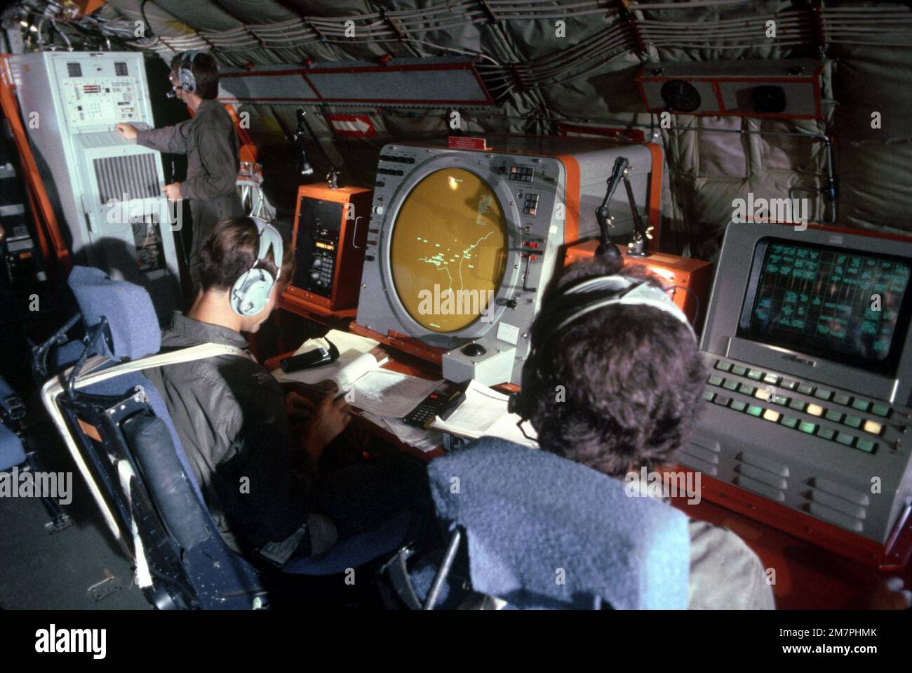U.S. Air Force officers monitor radar consoles aboard an NKC-135 ...