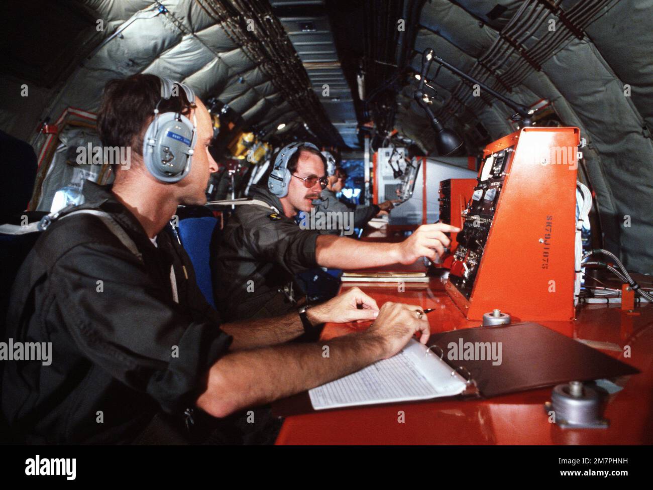 United States Air Force officers monitor radar consoles aboard an NKC ...