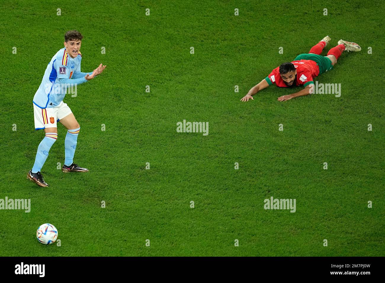 Spain's Gavi, left, reacts as Morocco's Sofiane Boufal lies on the ...