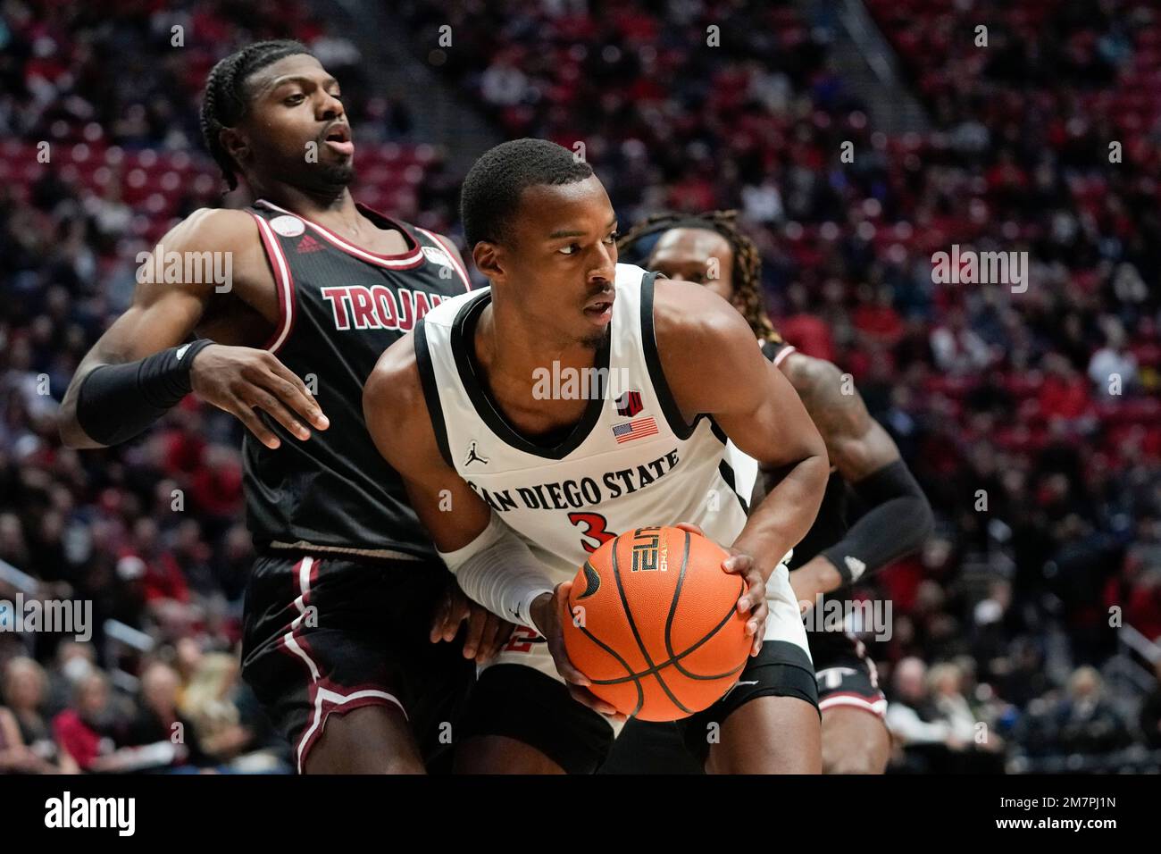 San Diego State guard Micah Parrish, right, looks to pass as Troy guard ...