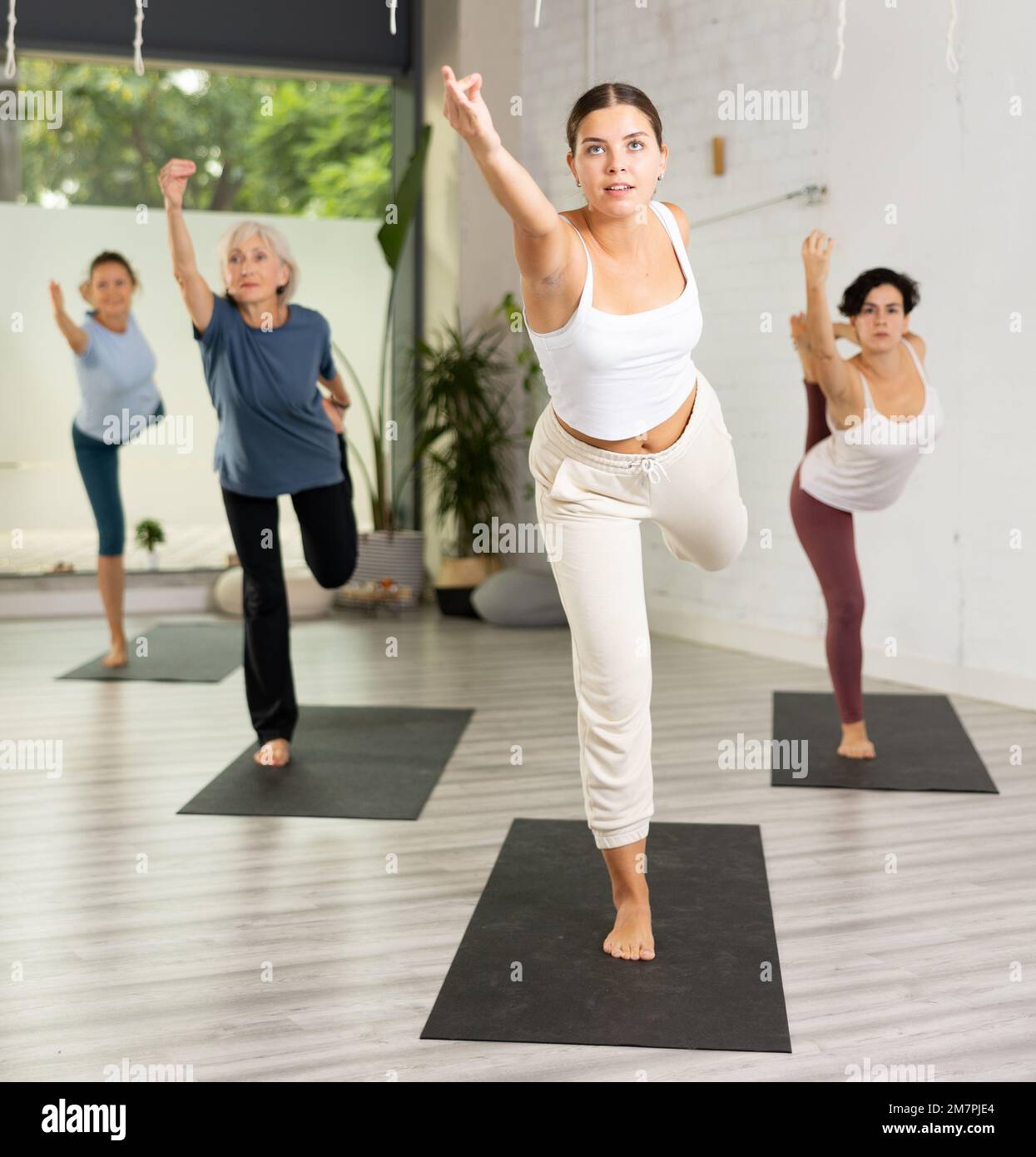 Young woman balancing in Natarajasana (Dancer Pose or Lord of the Dance ...