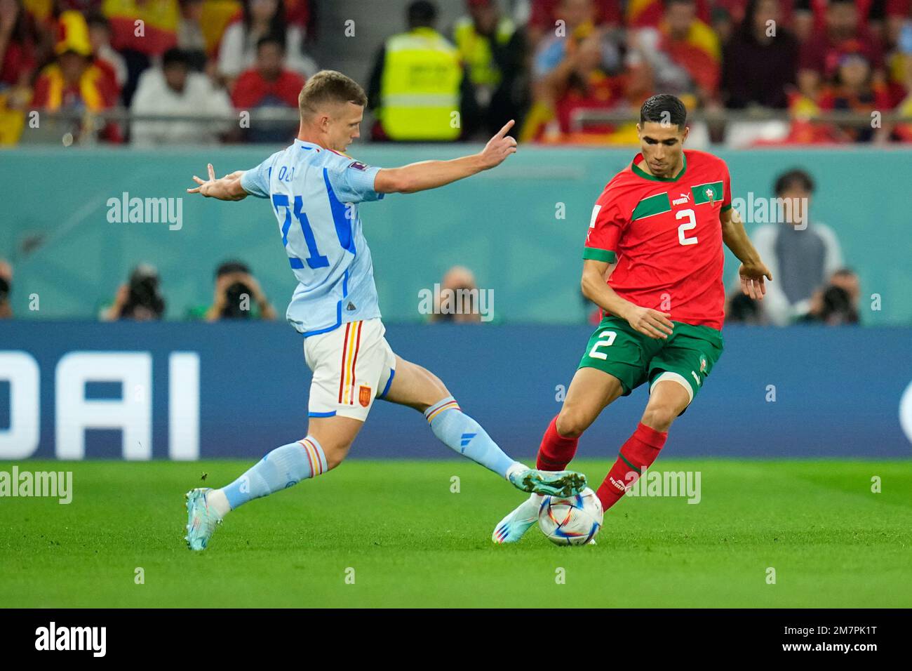 Spain's Dani Olmo, left, and Morocco's Achraf Hakimi vie for the ball ...