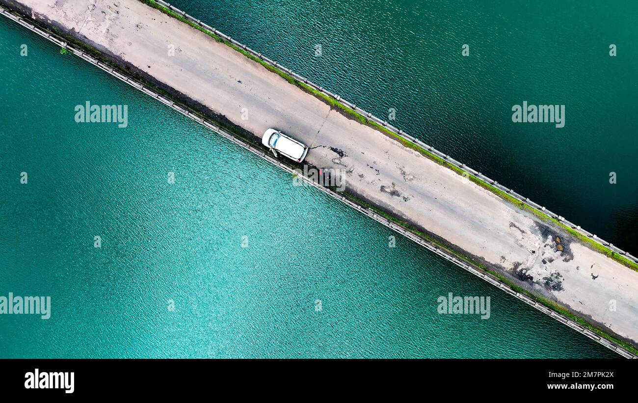 An aerial view of a car driving over the bridge over the river Stock ...