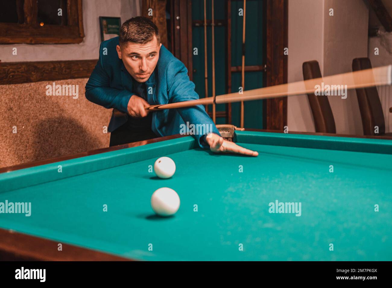 Playing billiards, a man as an amateur plays billiards, a sports board ...