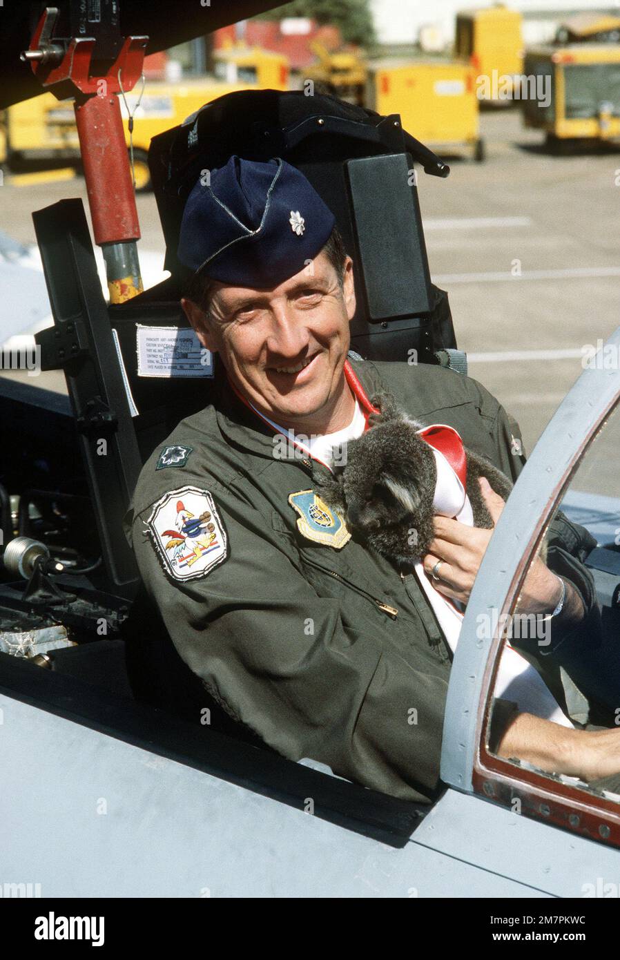 LTC O'Kane poses with a baby Koala bear, aboard an F-15 Eagle aircraft ...