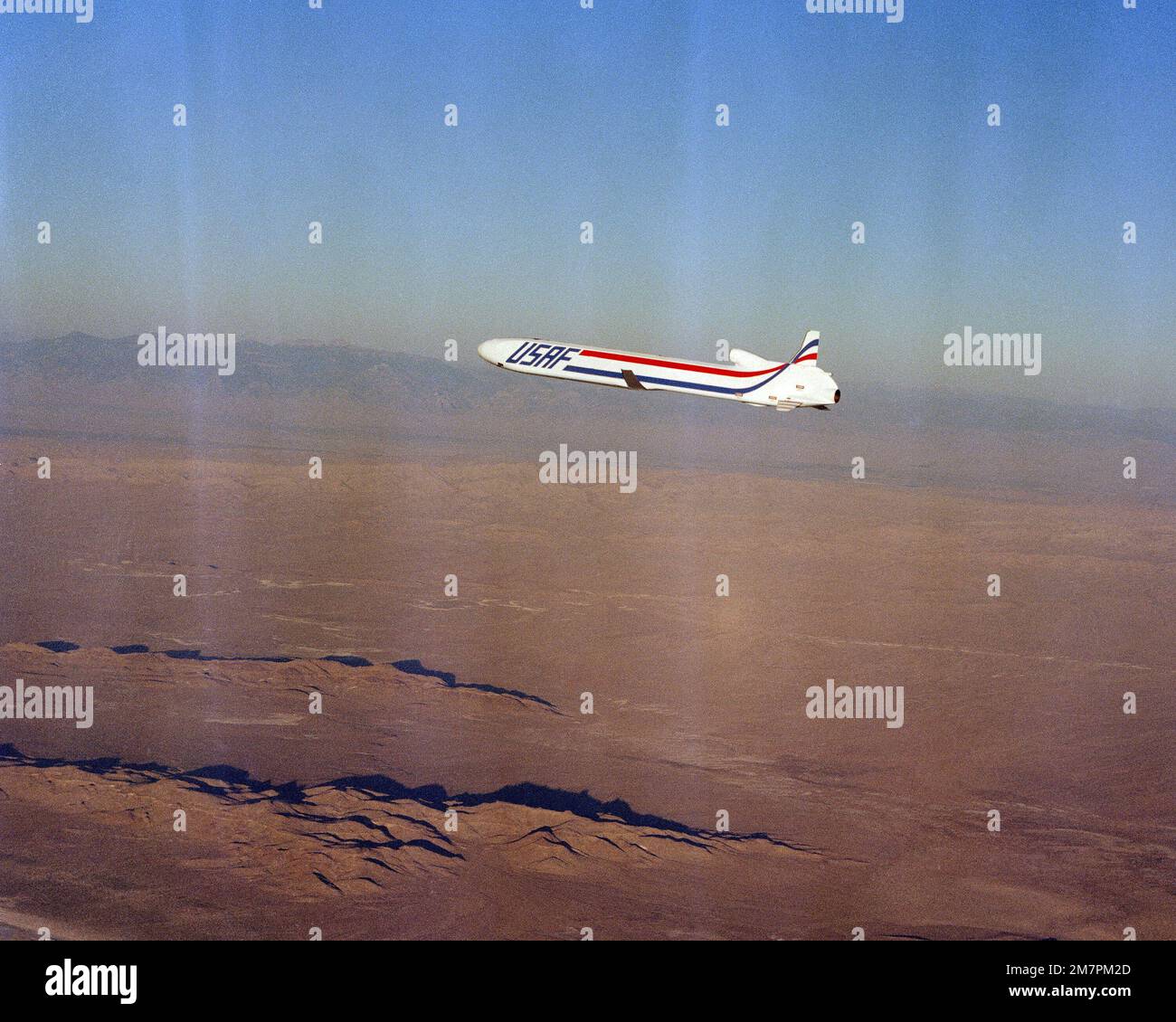 A side view of an AGM-86 air-launched cruise missile (ALCM) in flight ...