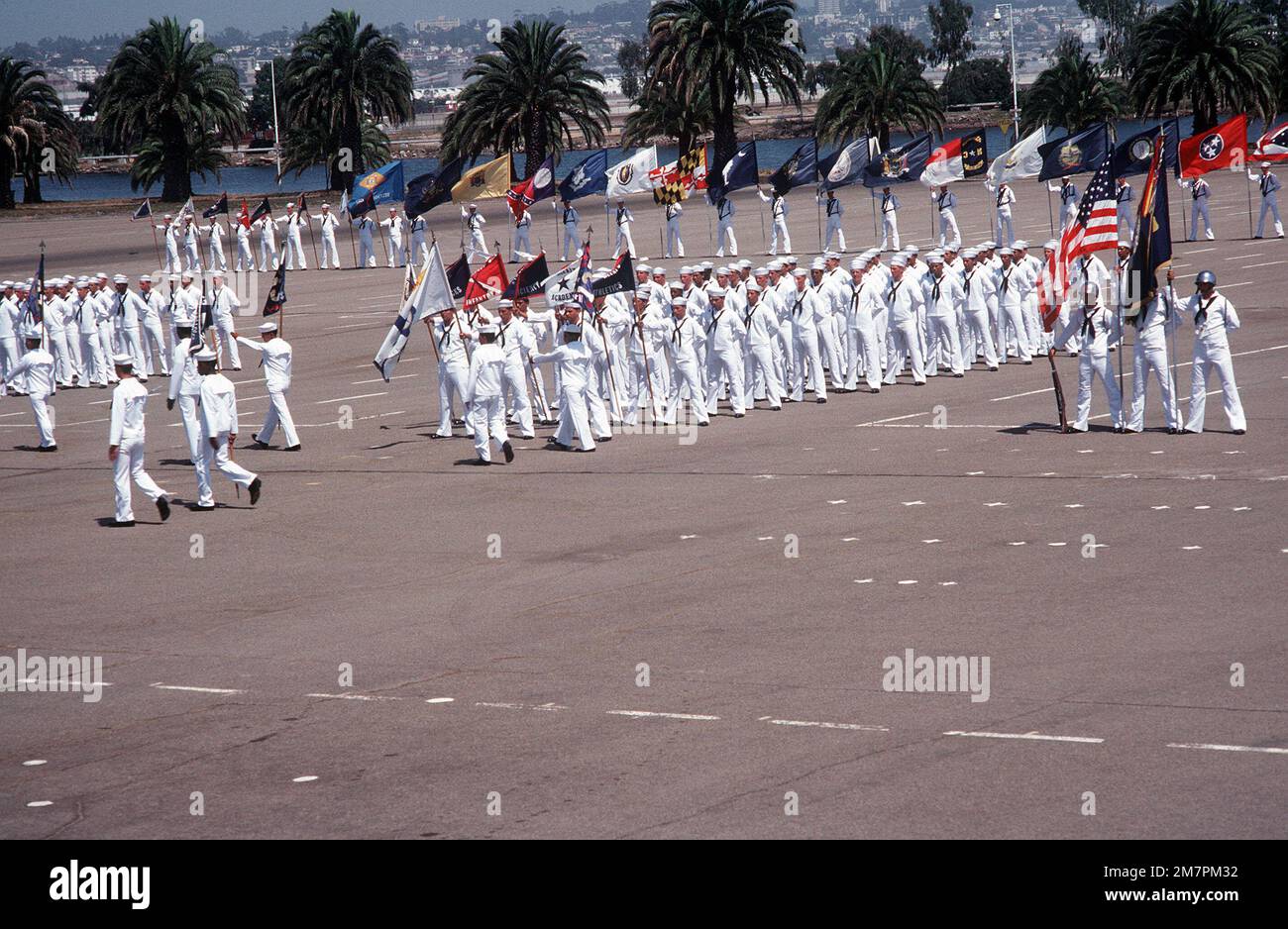 A U.S. Navy color guard and drill team performs at the foot of Broadway ...