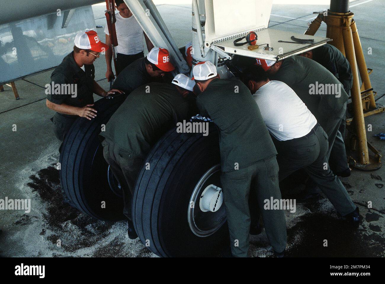 Maintenance crew members change a seal on an E-3A Airborne Warning and ...