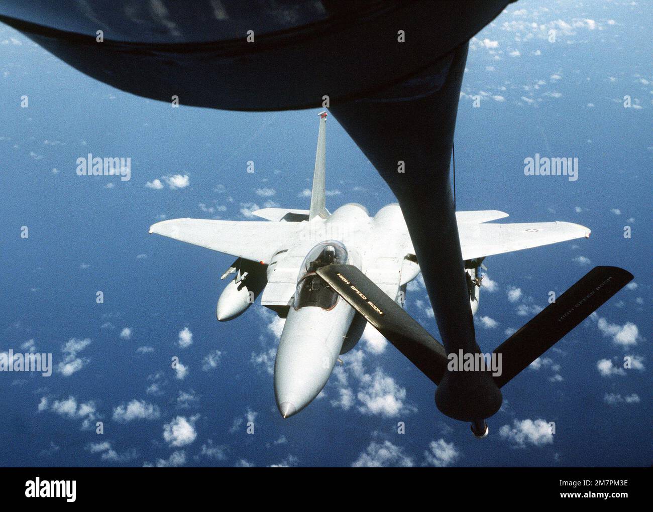 In-flight view of an F-15 Eagle aircraft, seen from a KC-135 Stratotanker aircraft boom operator ...