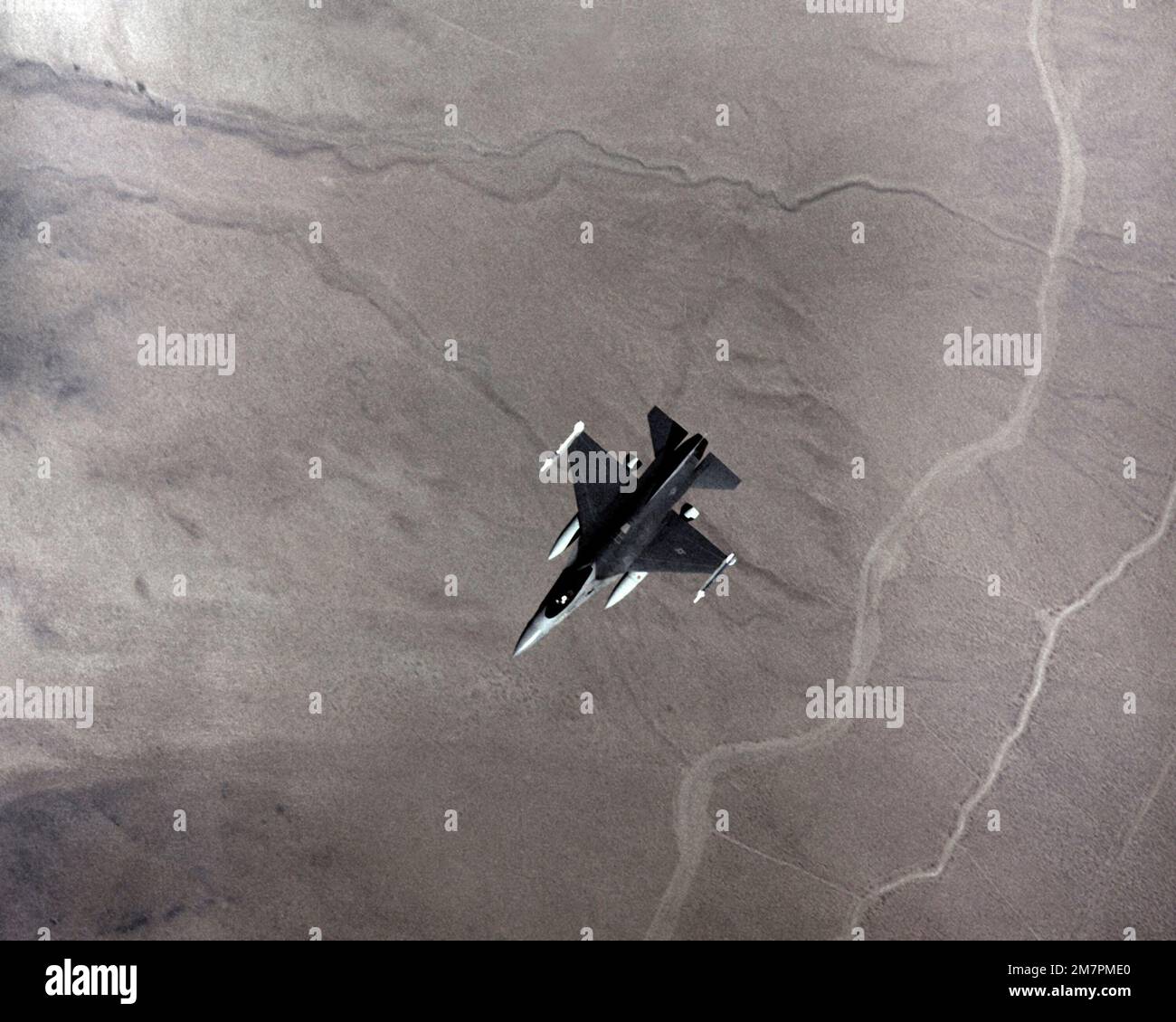 An air-to-air overhead view of an F-16A Fighting Falcon aircraft with ...
