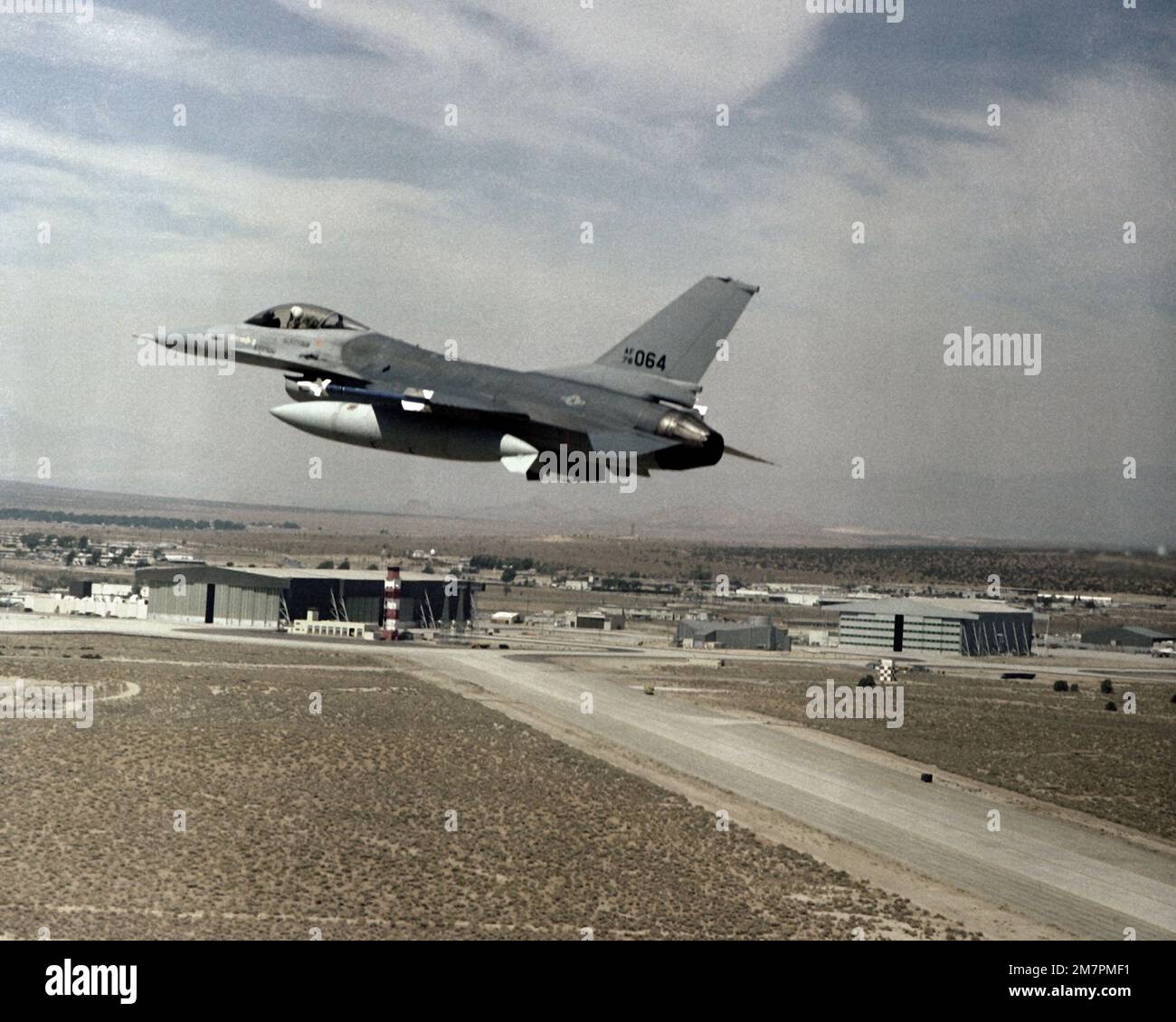 An air-to-air left side view of an F-16A Fighting Falcon aircraft with ...