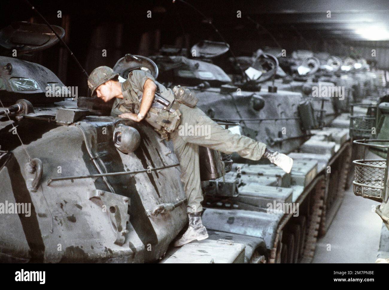 A member of the Army 34th Armor Division readies tanks for the ...