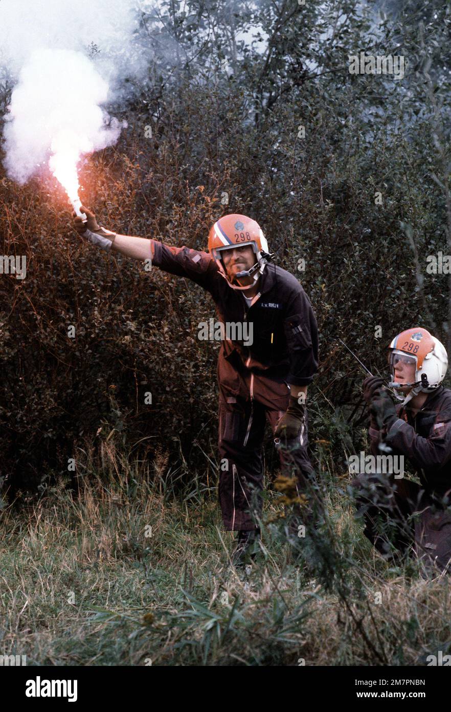 A "downed" Dutch Air Force helicopter crewman SGT Chris Welter contacts ...