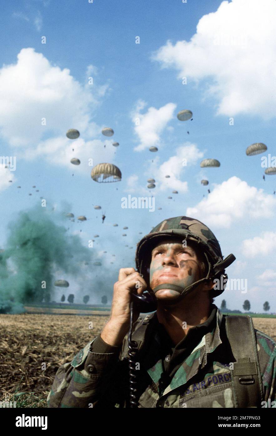 A combat control team member on a drop zone uses a field radio to ...